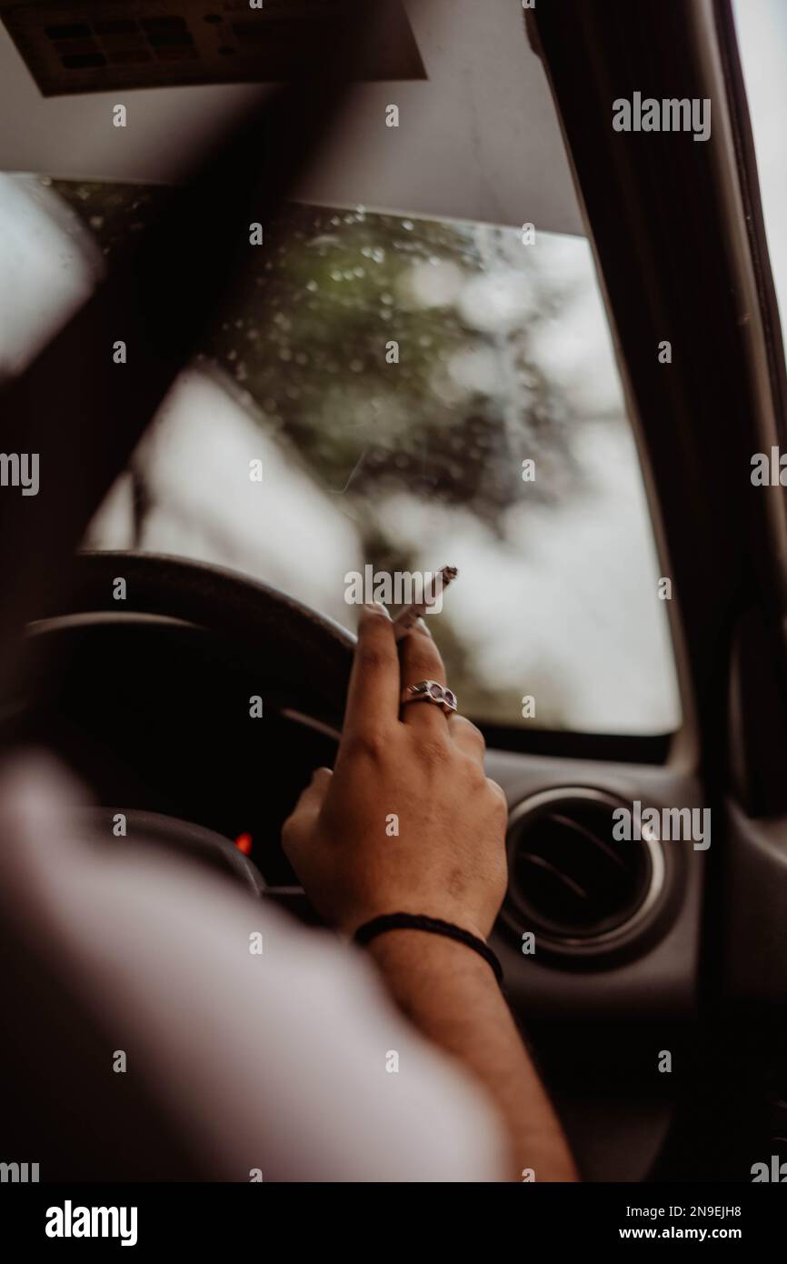 Man smoking cigarette driving hi-res stock photography and images - Alamy
