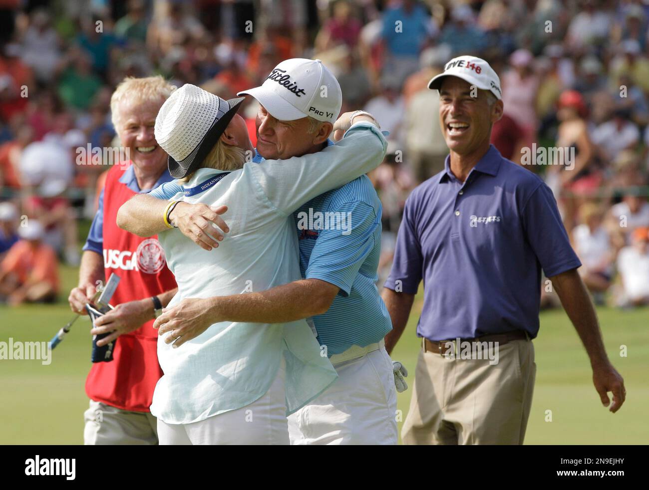 Roger Chapman hugs his wife Cathy as Chapman's caddie Kevin Laffey ...