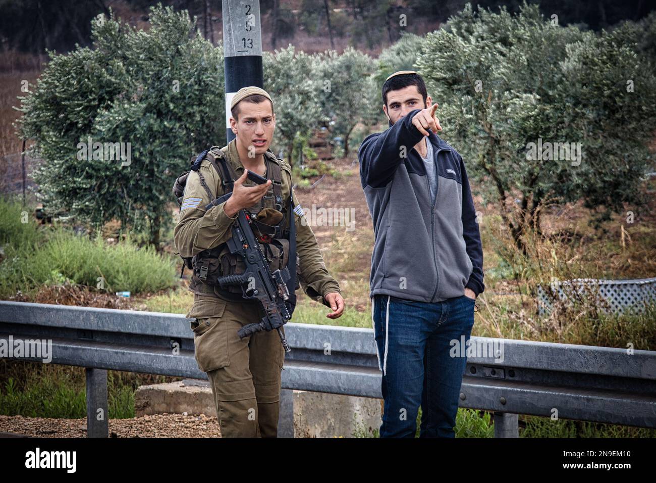 A Golani soldier and a citizen standing and talking in the city of ...