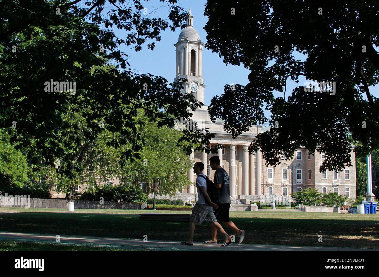 A Penn State University student walks across campus in front of Old ...