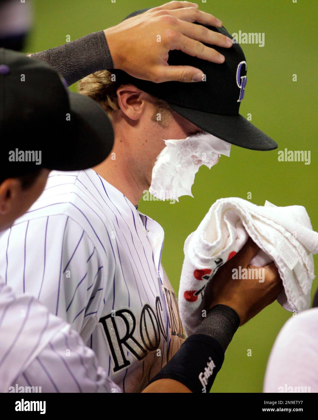 Colorado Rockies' Josh Rutledge, right, has his face covered with ...