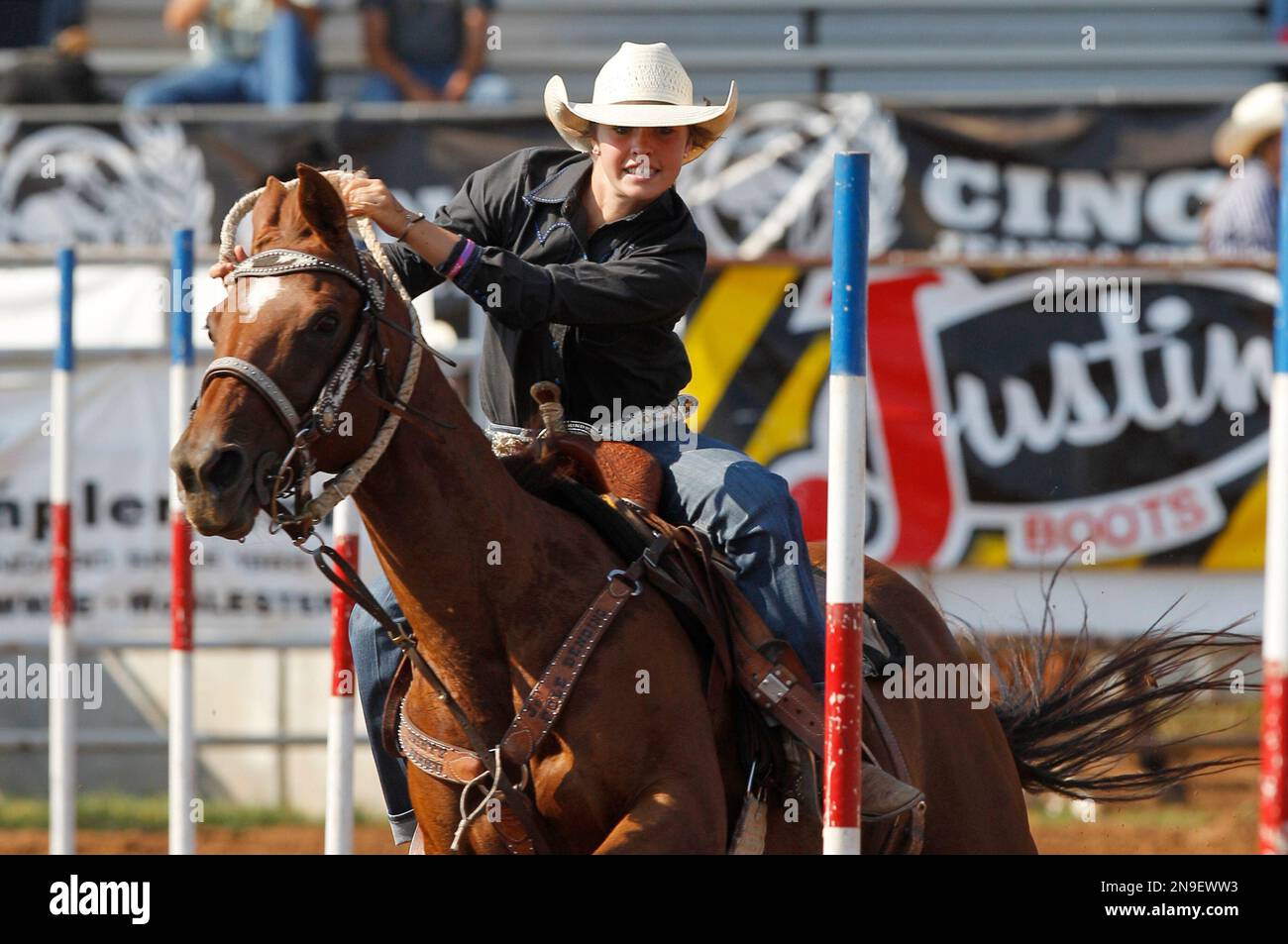 Taylor Engesser, of Spearfish, S.D., rides in the pole bending event on ...