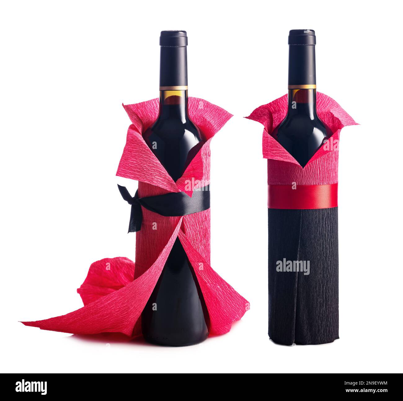 Bottles of red wine wrapped in crepe paper isolated on a white ...