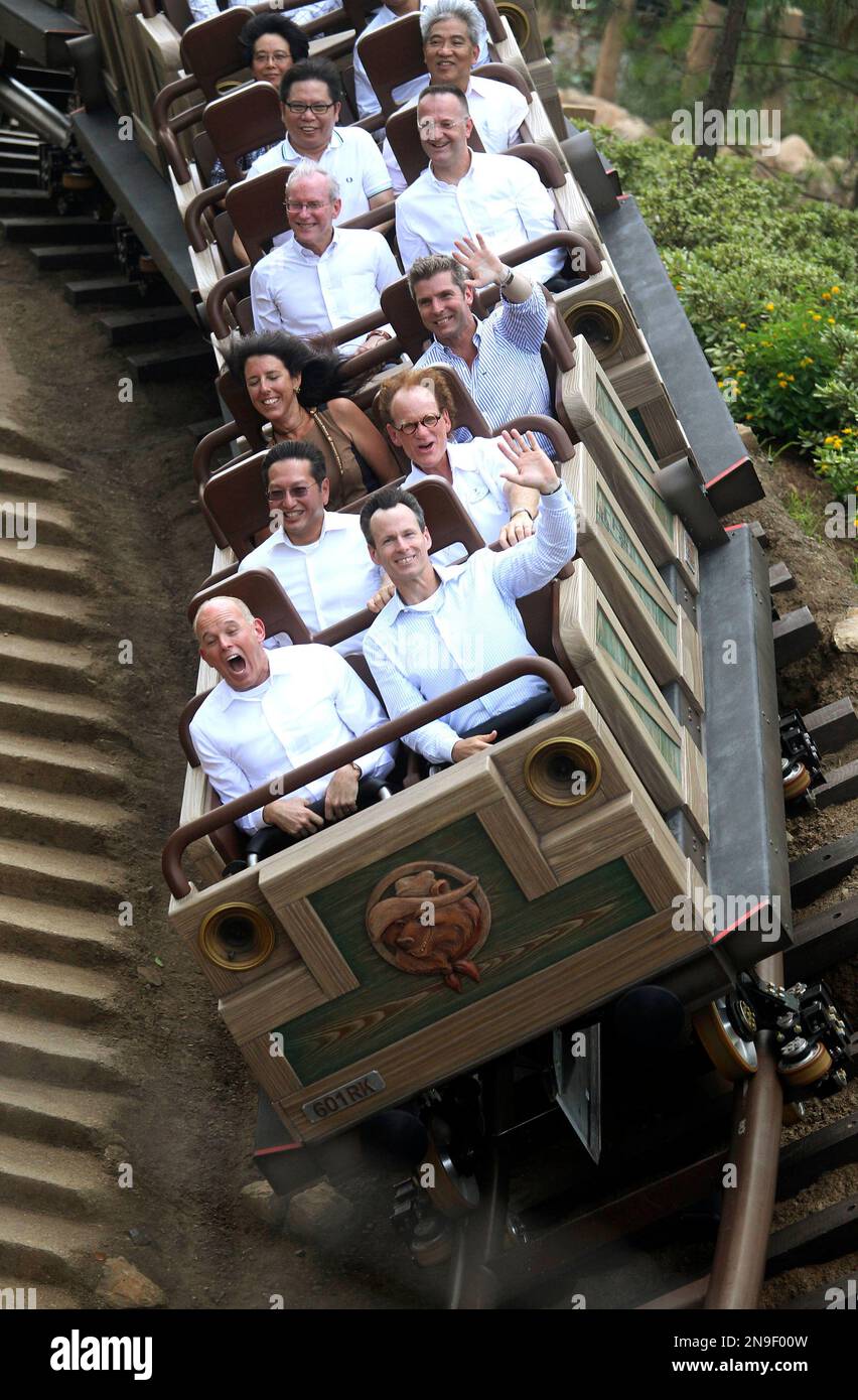 Chairman of Walt Disney Parks and Resorts Tom Staggs, front right, and ...