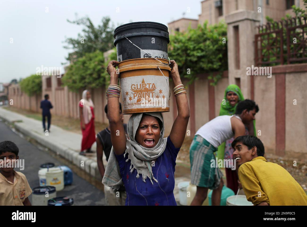 In this photo taken Friday, July 6, 2012, an Indian woman carries ...