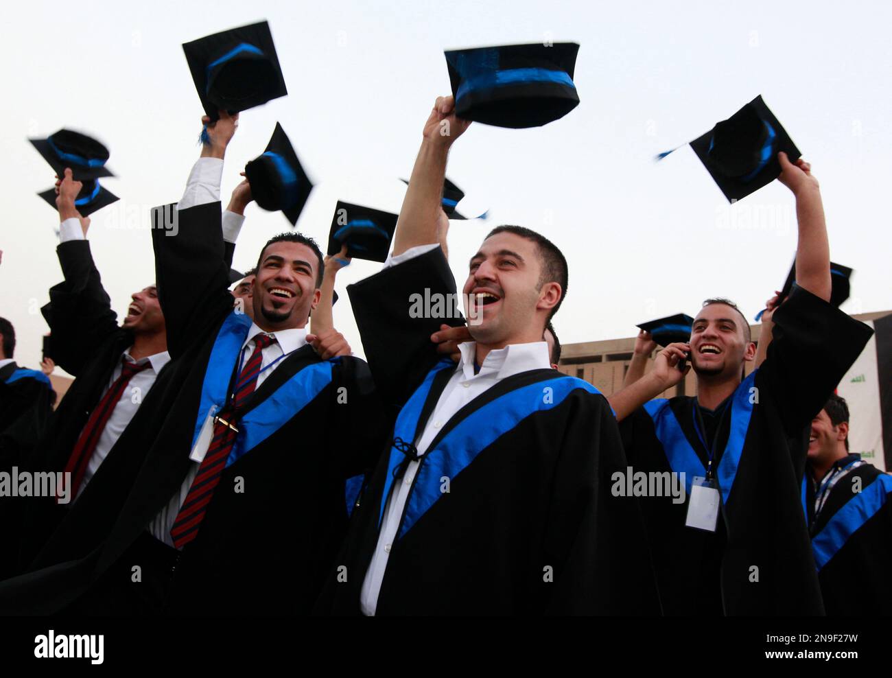 Graduates celebrate during a graduation ceremony in Baghdad, Iraq ...