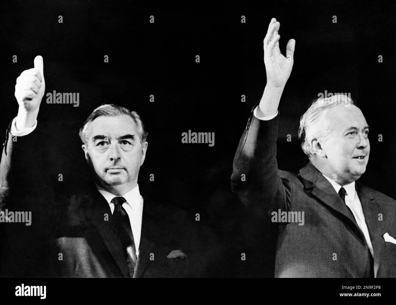 Harold Wilson, right, leader of the British Labor Party, waves to crowd ...