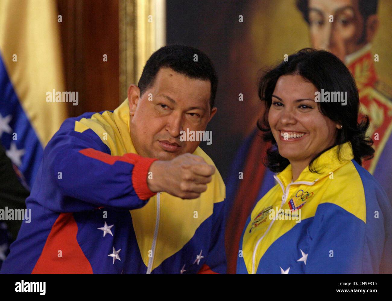 Venezuela's President Hugo Chavez, left, jokes with table tennis player ...