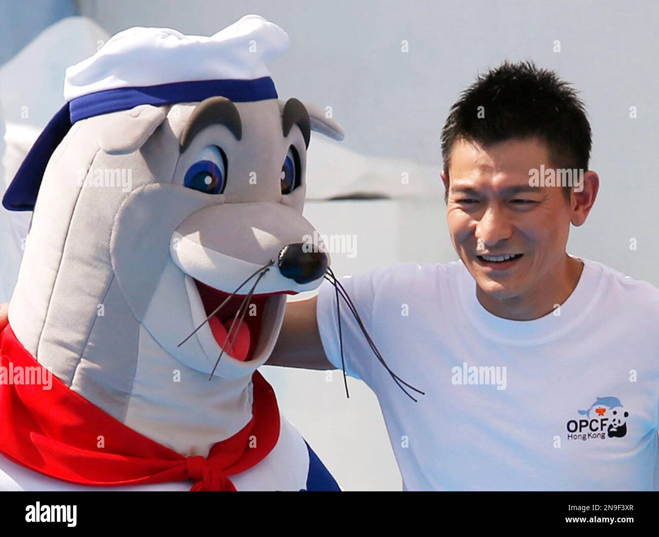 Hong Kong movie star Andy Lau poses with the Ocean Park mascot at the ...
