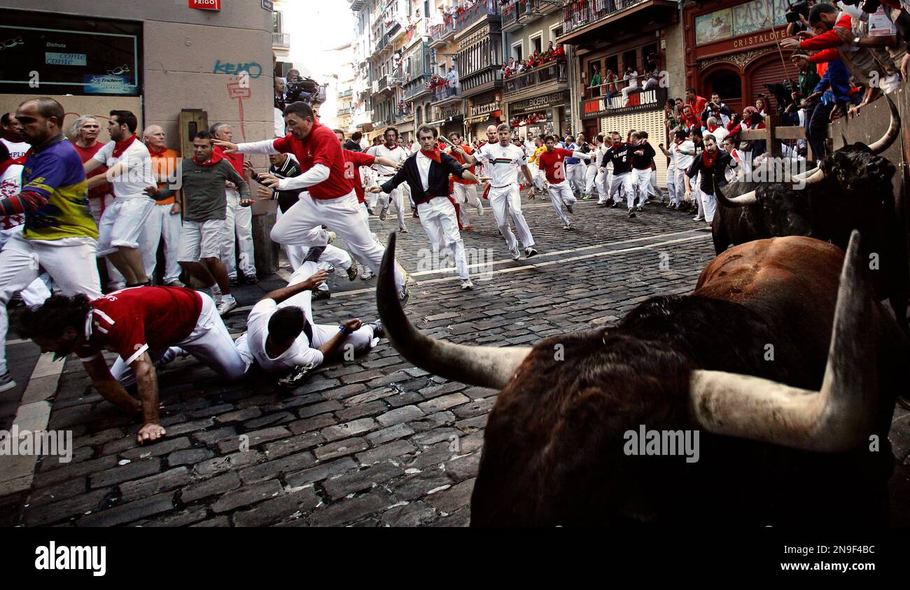 Revelers run and fall in front of Victoriano del Rio's ranch fighting ...