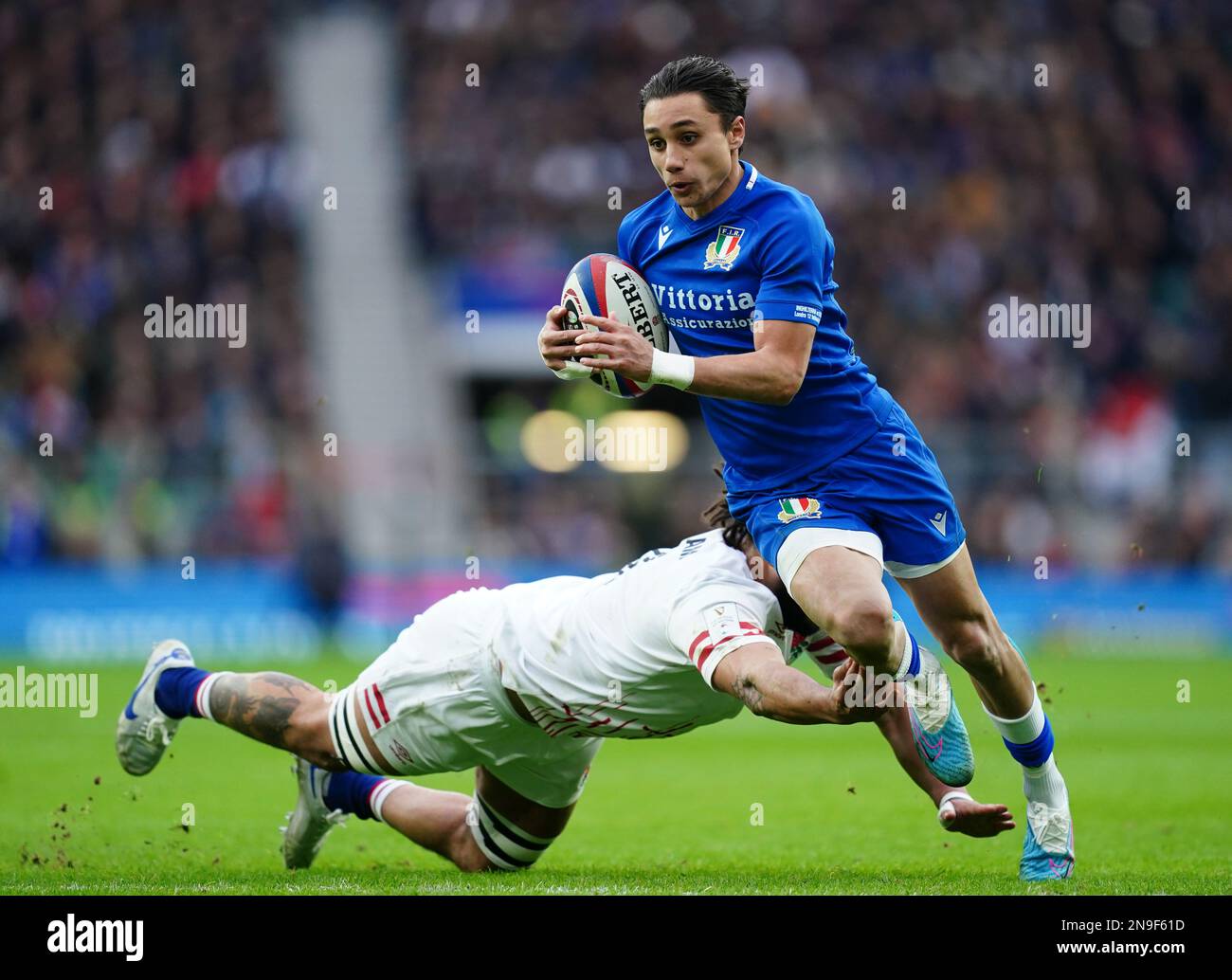 Italy's Ange Capuozzo (right) tackled by England's Lewis Ludlam during ...