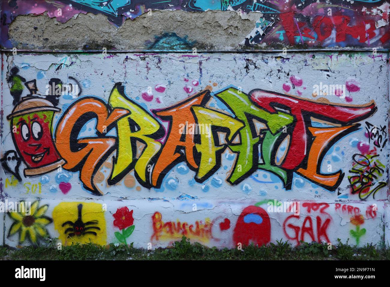 A wall covered by colorful spray paint art spelling "graffiti" in ...