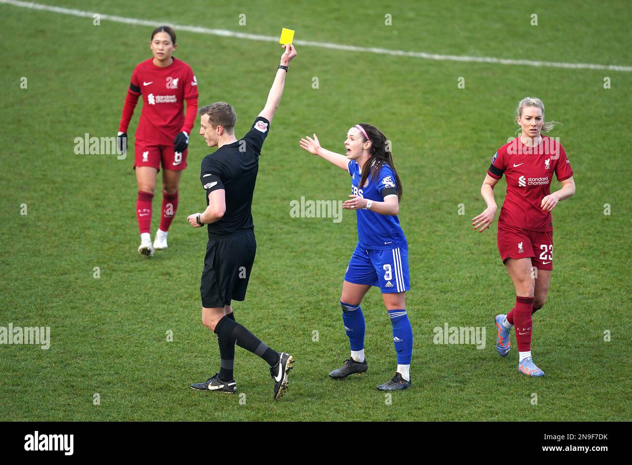 Referee Richie Watkins (left) shows a yellow card to Leicester City's ...