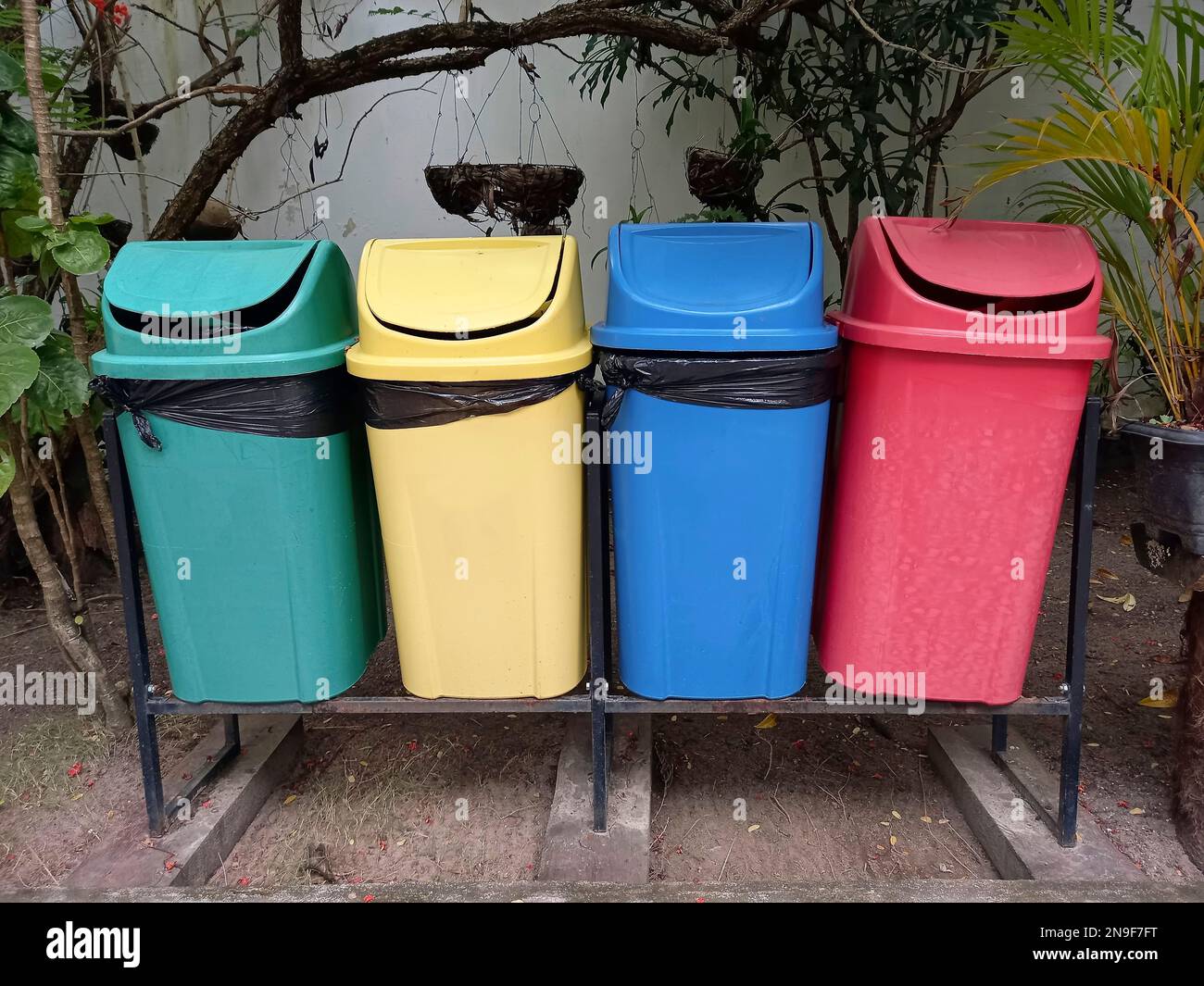 several plastic bins with different colors for garbage collection and ...