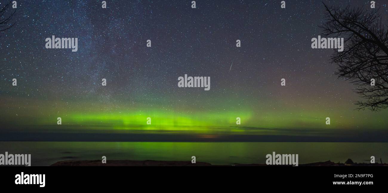 A breathtaking view of a starry sky with the green glow of the northern ...