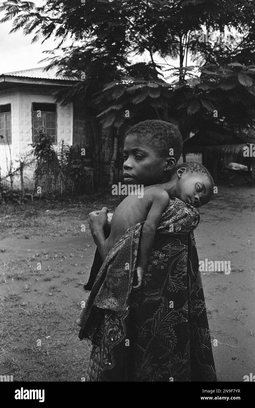 An Ibo woman refugee, carrying her dead child over her shoulder ...