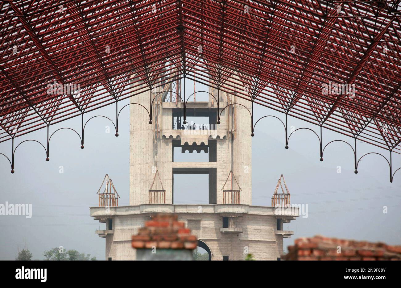 A photo shoot can be seen taking place in a half completed castle at an ...