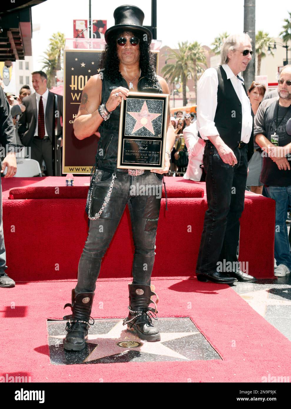 Slash poses with his star at a Hollywood Walk of Fame ceremony on ...