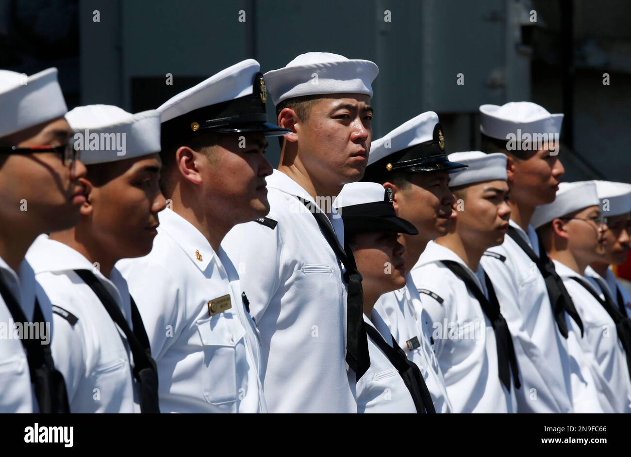 U.S. navy sailors stand on the deck of aircraft carrier USS George ...
