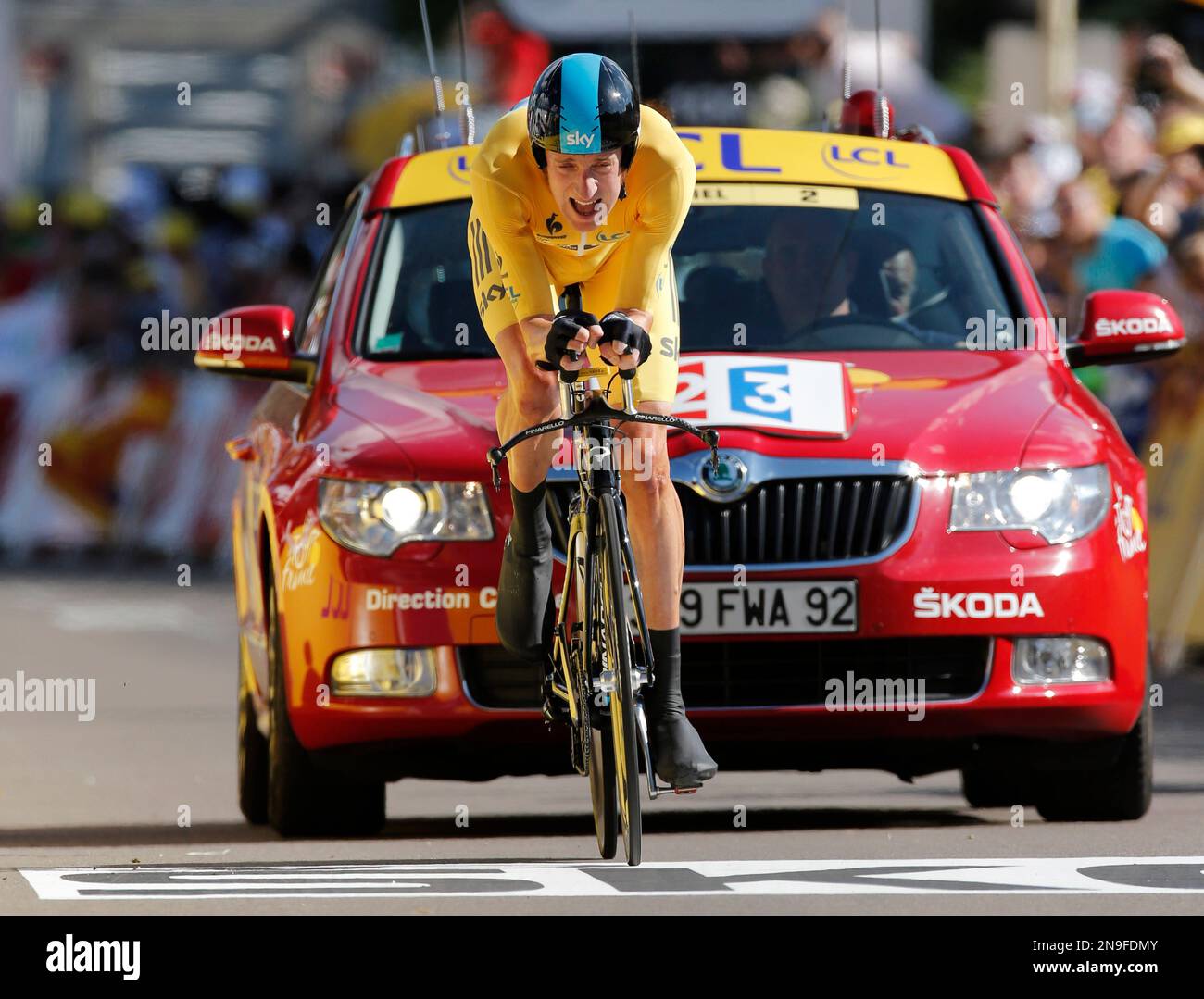 Bradley Wiggins of Britain, wearing the overall leader's yellow jersey ...