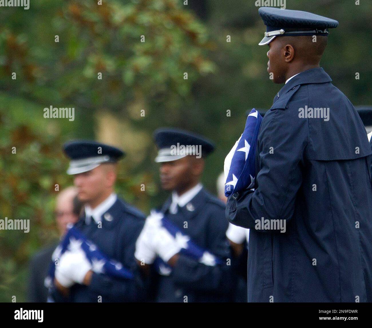 Members of the Air Force Honor Guard hold American flags to be ...