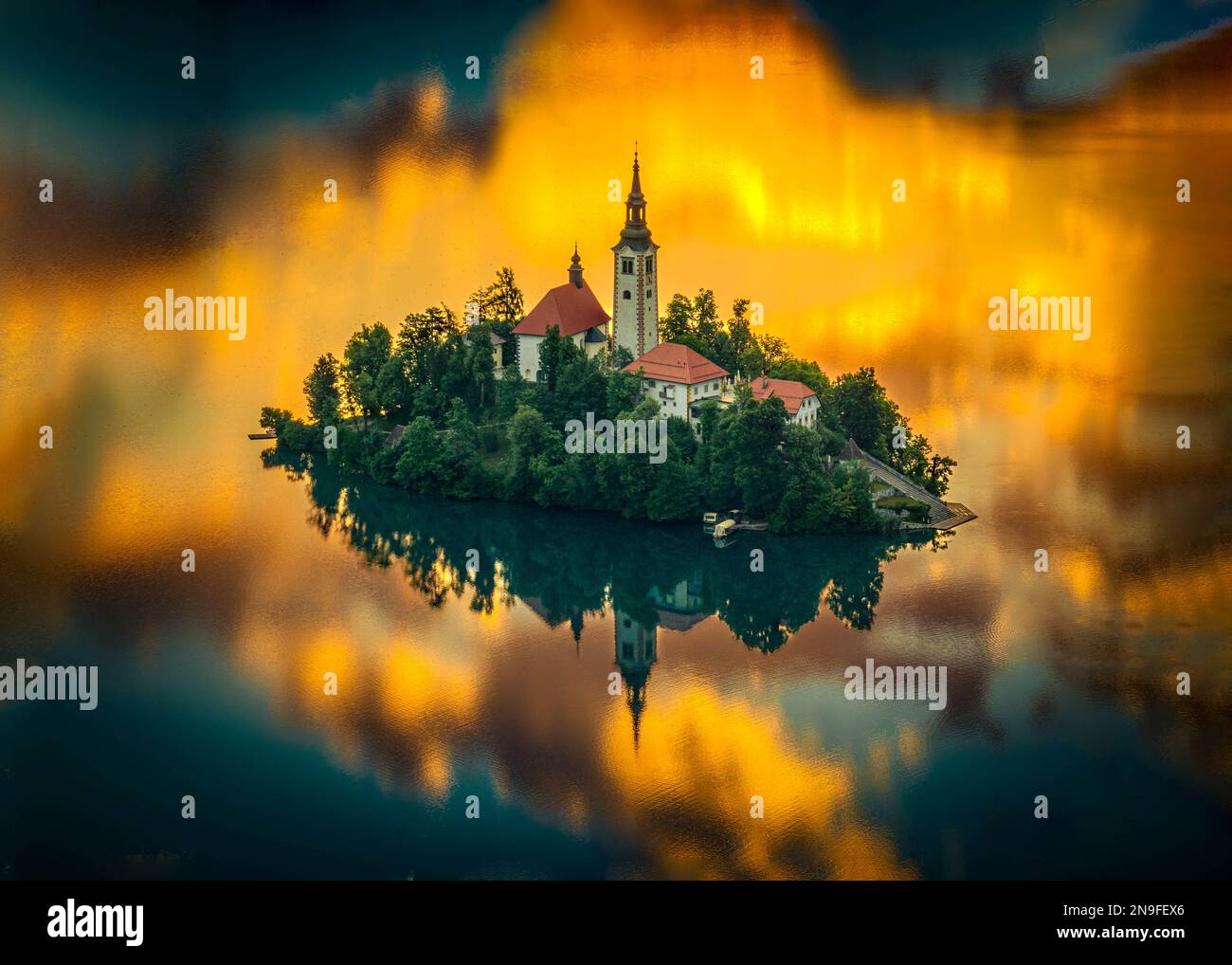 Picturesque sunrise on the lake Bled. Perfect reflection of the church ...
