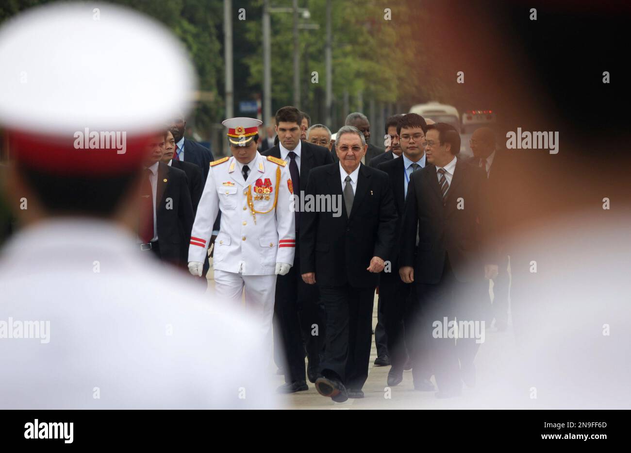 Cuban President Raul Castro, center, arrives at the mausoleum of former ...