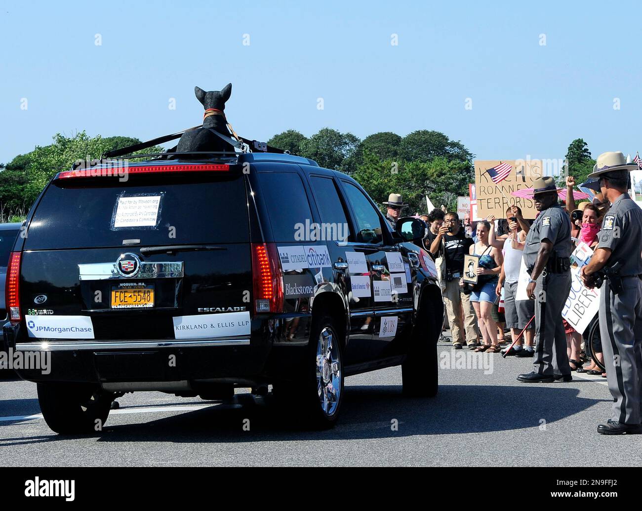 A vehicle labeled the "Romney Mobile" with a dog tied to the roof ...
