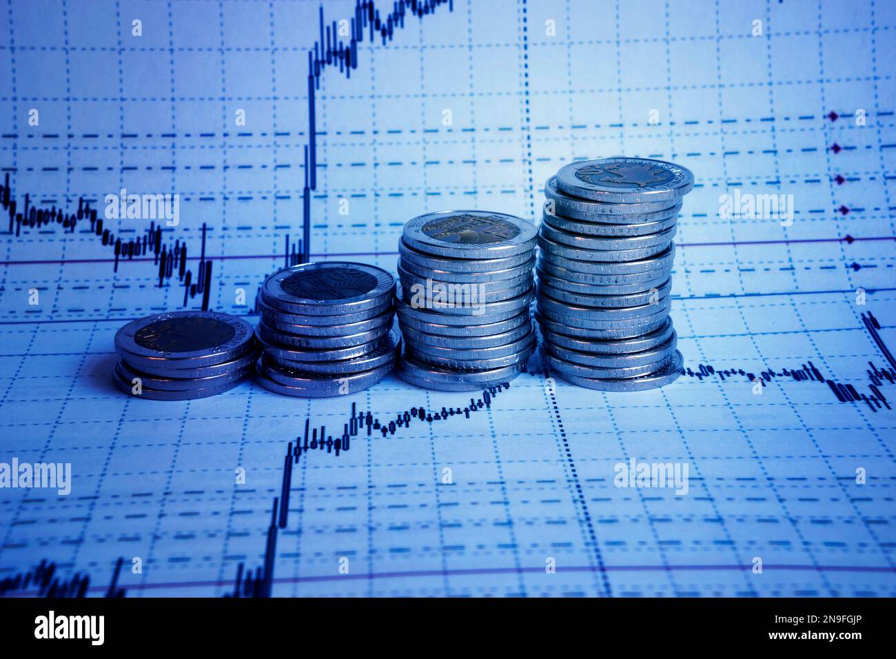 Business diagram on financial report with coins Stock Photo - Alamy