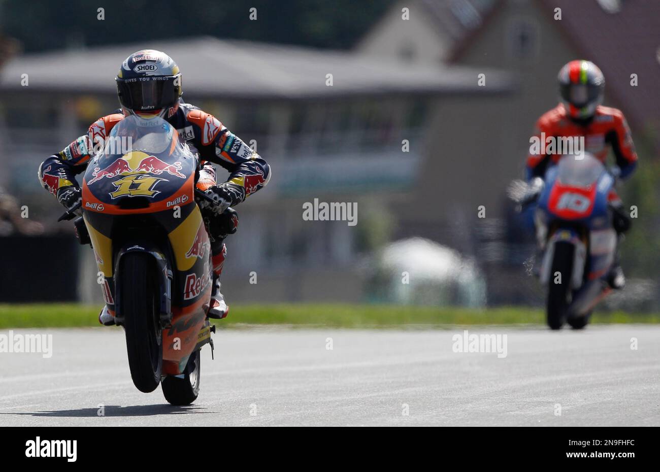 KTM rider Sandro Cortese, left, from Germany crosses the finish line ...