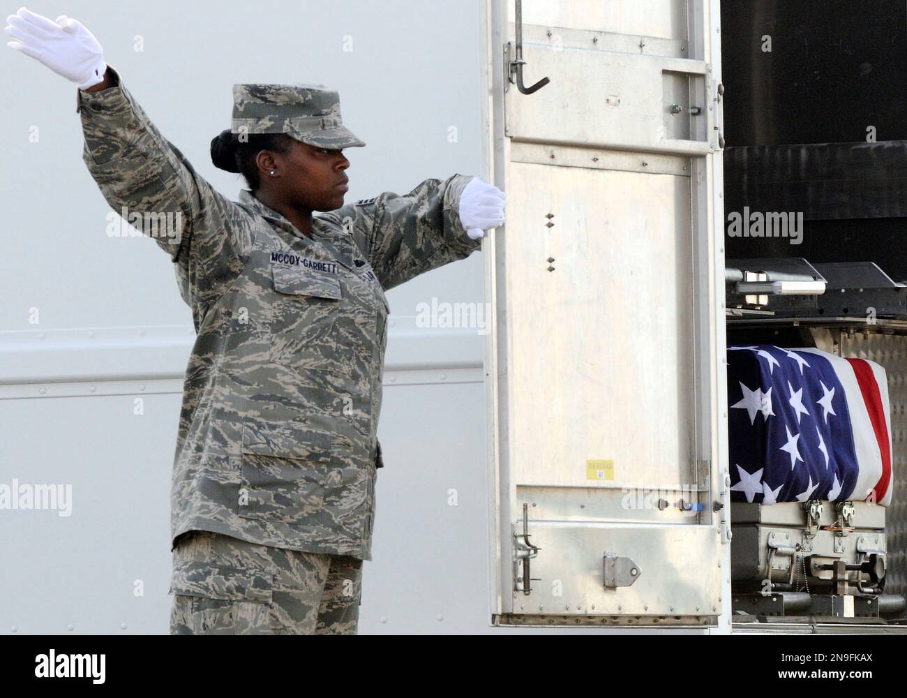Senior Airman Mercedes McCoy-Garrett closes a transfer vehicle holding ...