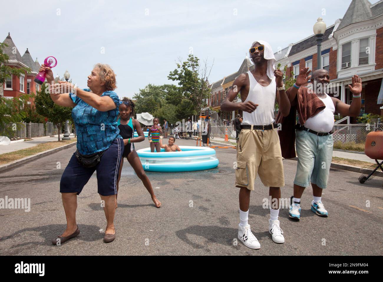 Holding a fan, Sandra Bears, left, dances along with Tracy Canty ...