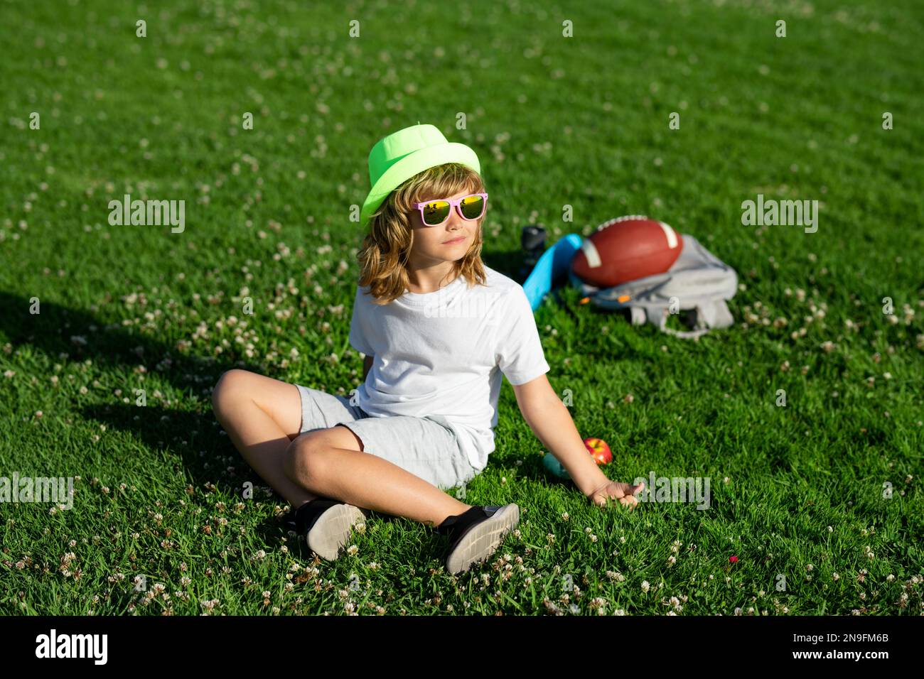 Kid boy relax at park outdoor. Summer weekend. Summertime vacation ...