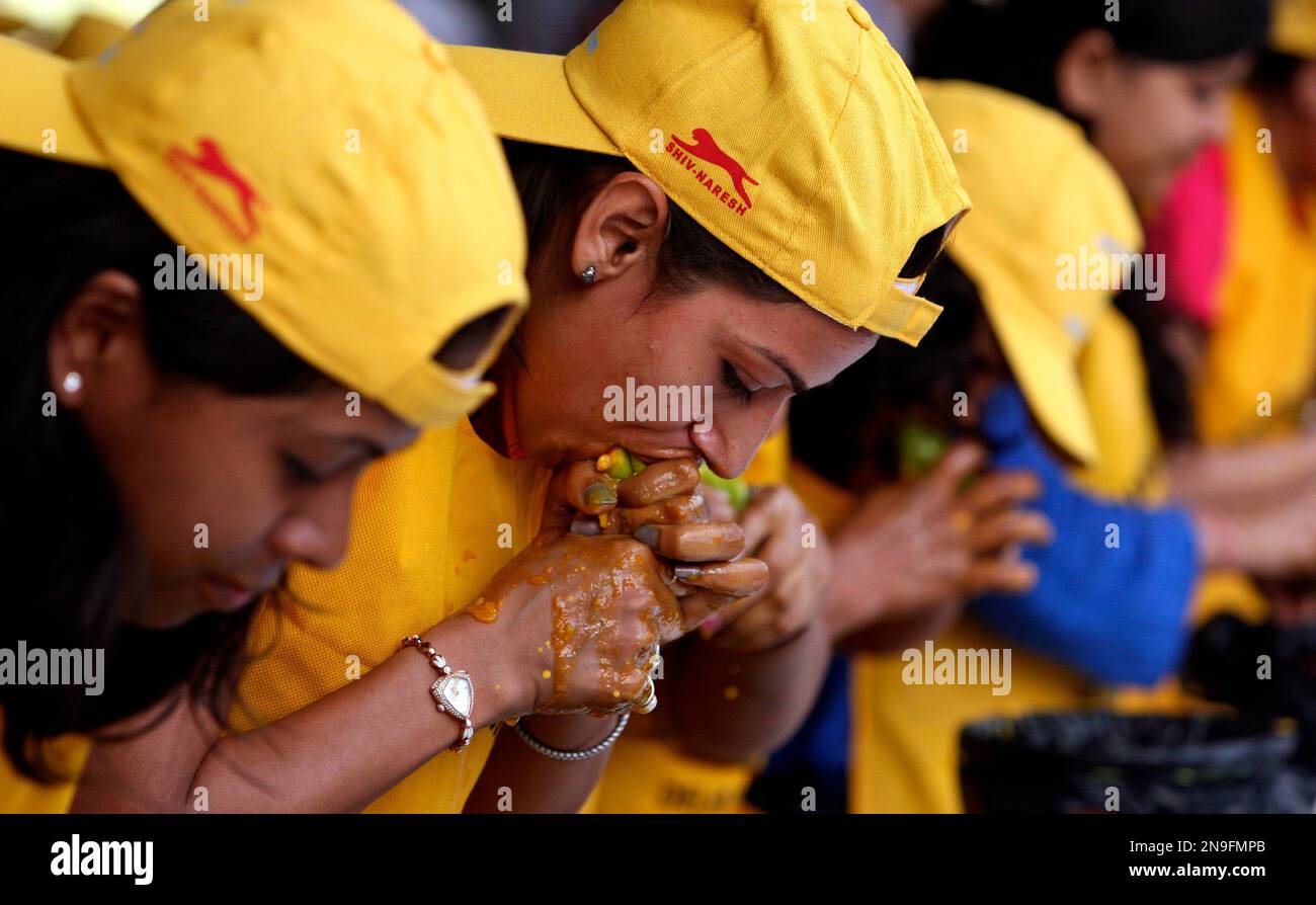 Indian woman participate in a mango eating contest at the annual mango ...