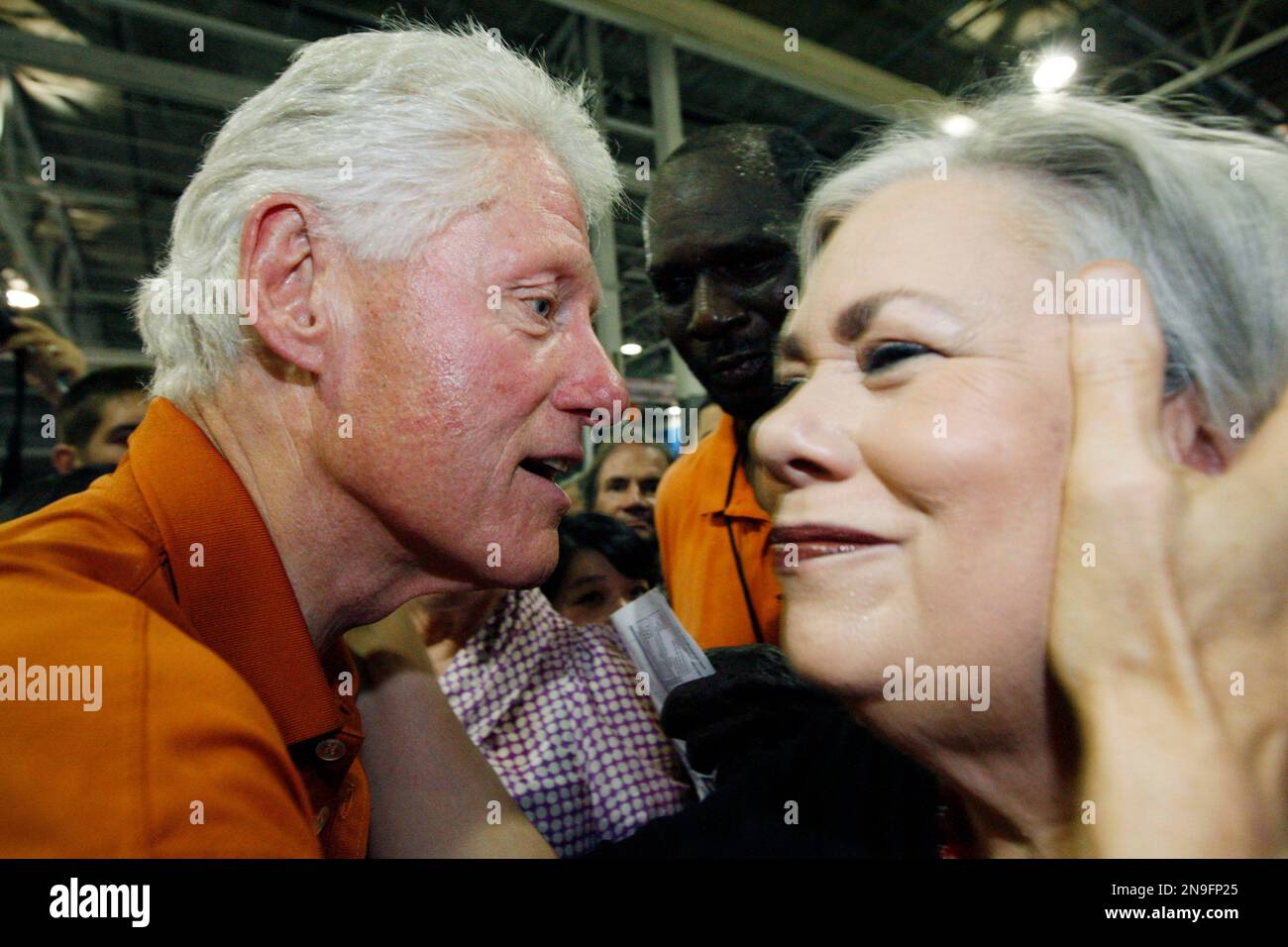 Former President Bill Clinton kisses a friend at GreenTech Automotive's ...