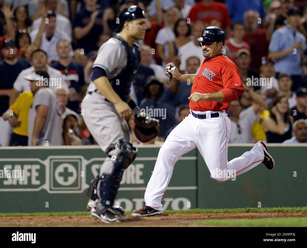 Boston Red Sox's Adrian Gonzalez scores on a single by Mauro Gomez as ...
