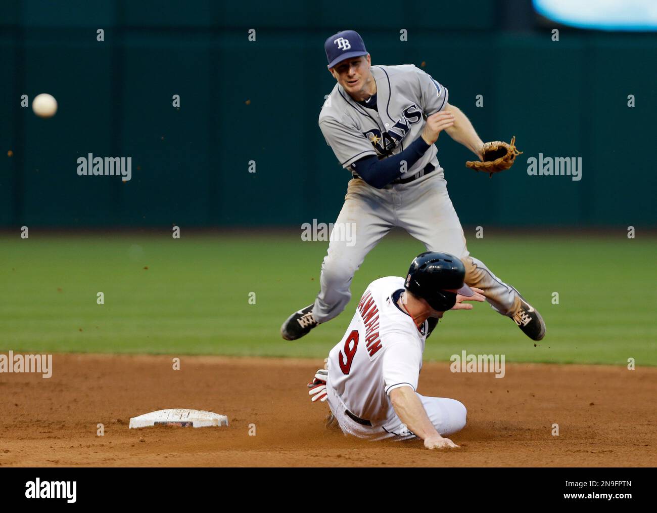 Tampa Bay Rays shortstop Elliot Johnson leaps over Cleveland Indians ...