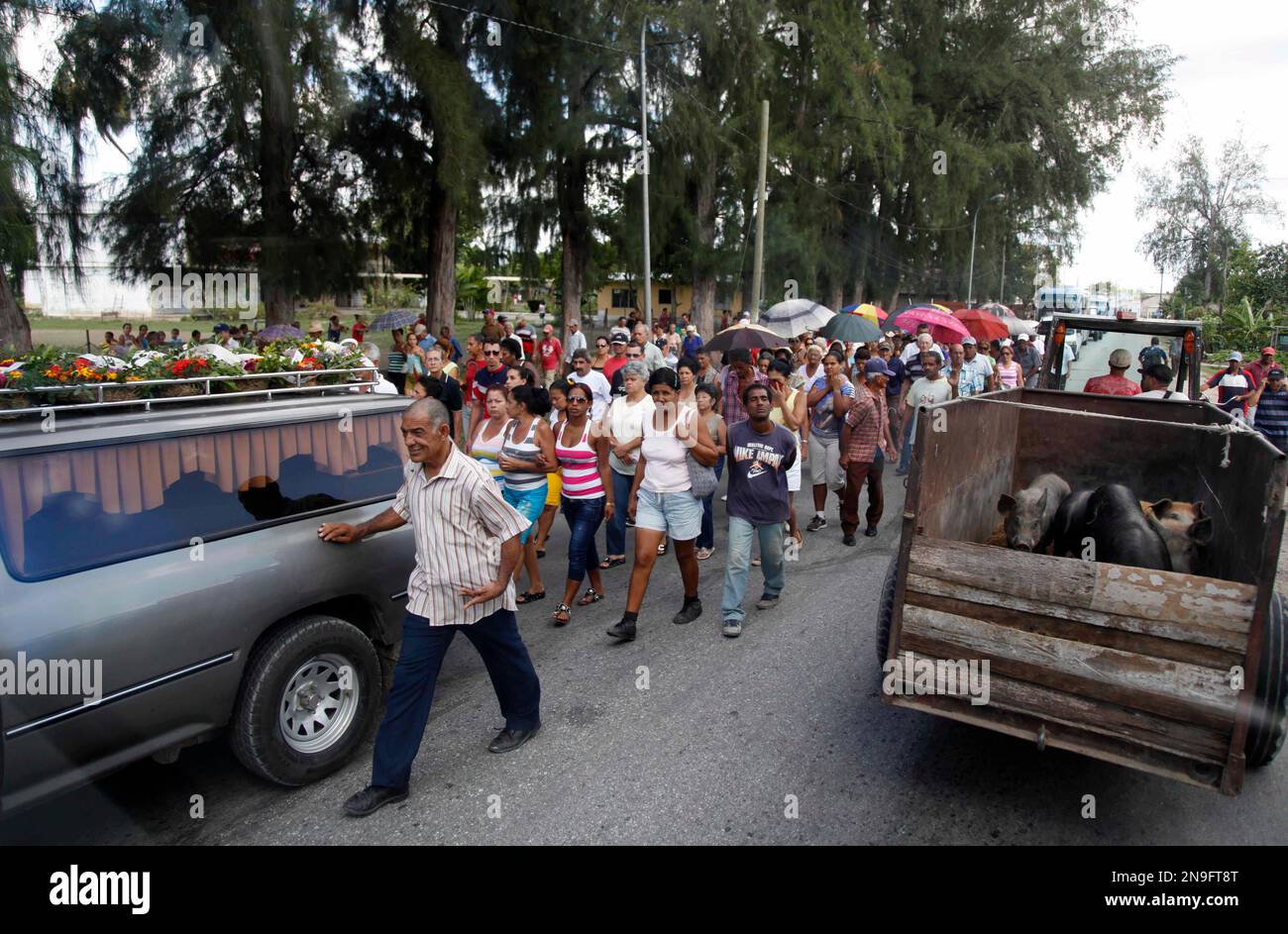 In this photo taken Monday April 23, 2012, pedestrians follow a hearse ...