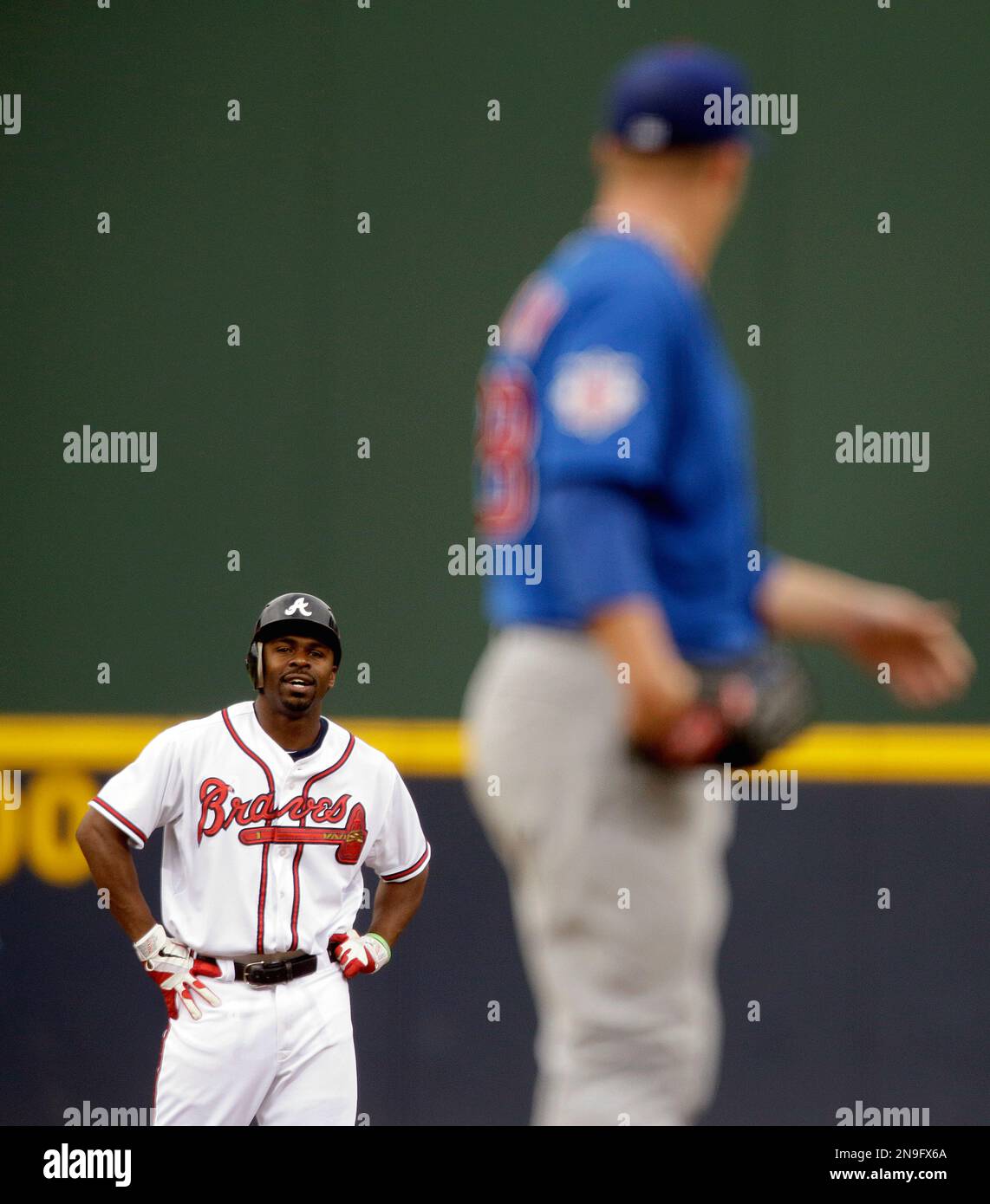 Atlanta Braves' Michael Bourn, rear, and Chicago Cubs starting pitcher ...