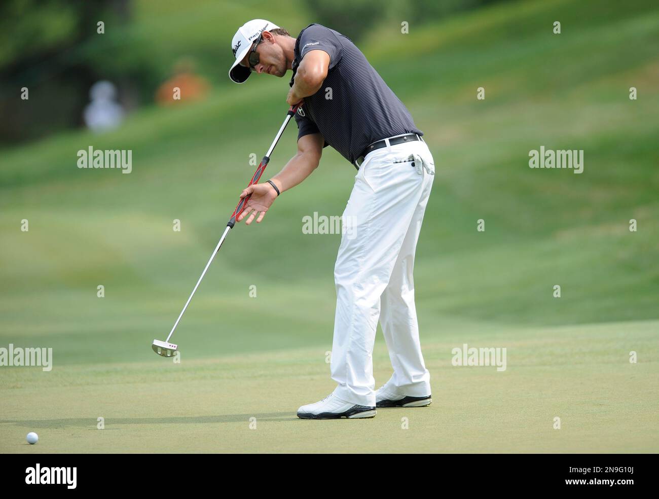 Adam Scott, of Australia, putts on the 15th hole during the final round ...