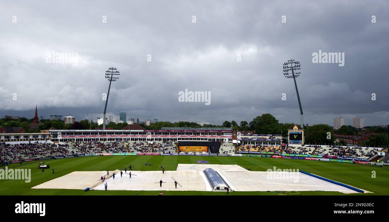 Ground staff work on the covers at the Egdbaston cricket ground as the ...