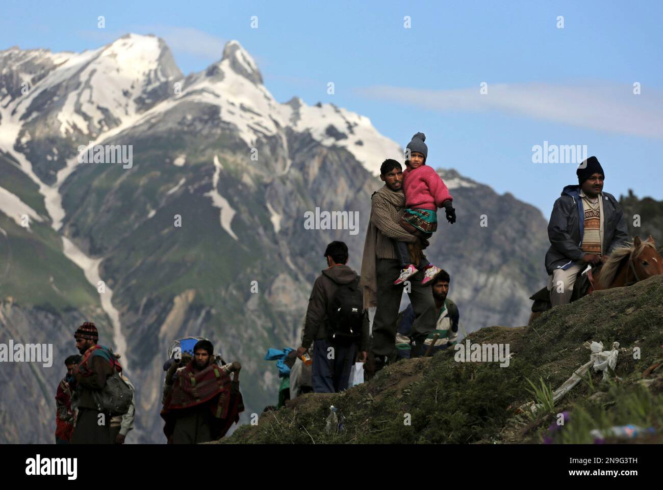 In this picture taken Saturday, June 30, 2012, a Kashmiri porter ...