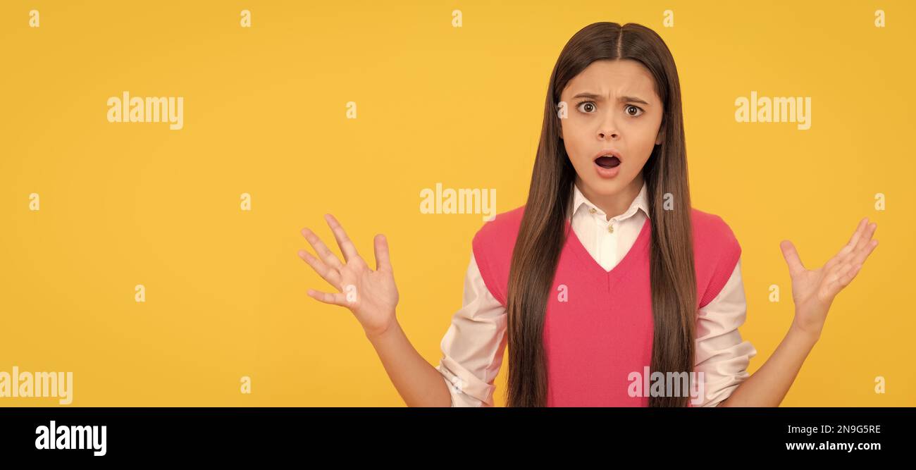shocked teen school girl smiling with long hair on yellow background ...