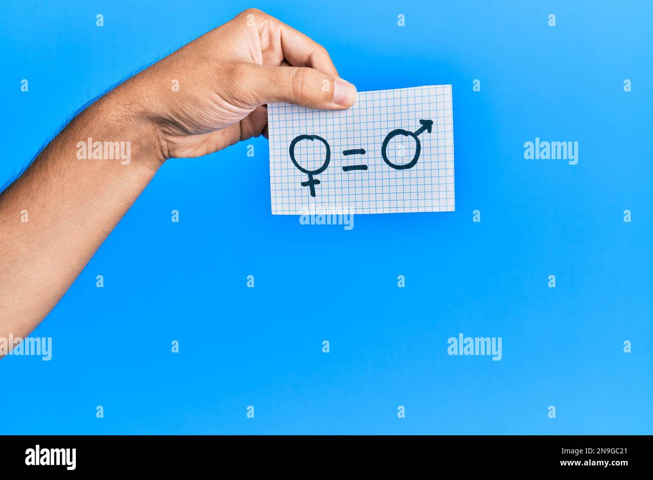 Hand of caucasian man holding paper with gender equality symbol message ...