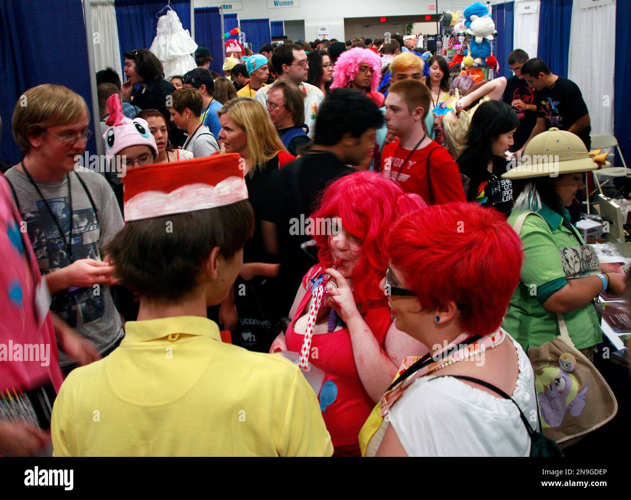 My Little Pony cartoon fans, some in Little Pony costumes, crowd isles ...