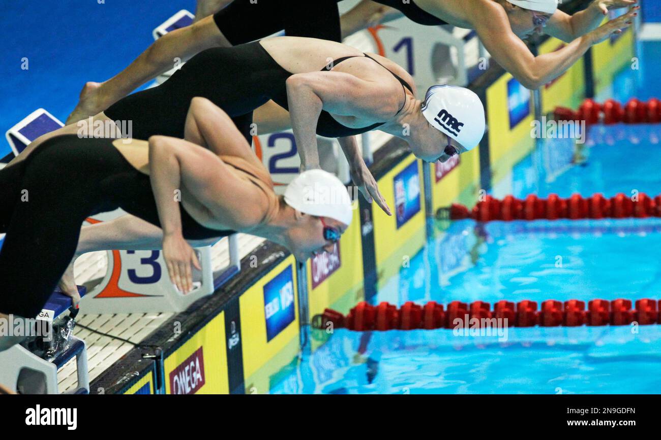 Christine Magnuson, left, and Kara Lynn Joyce dive at the start of a ...
