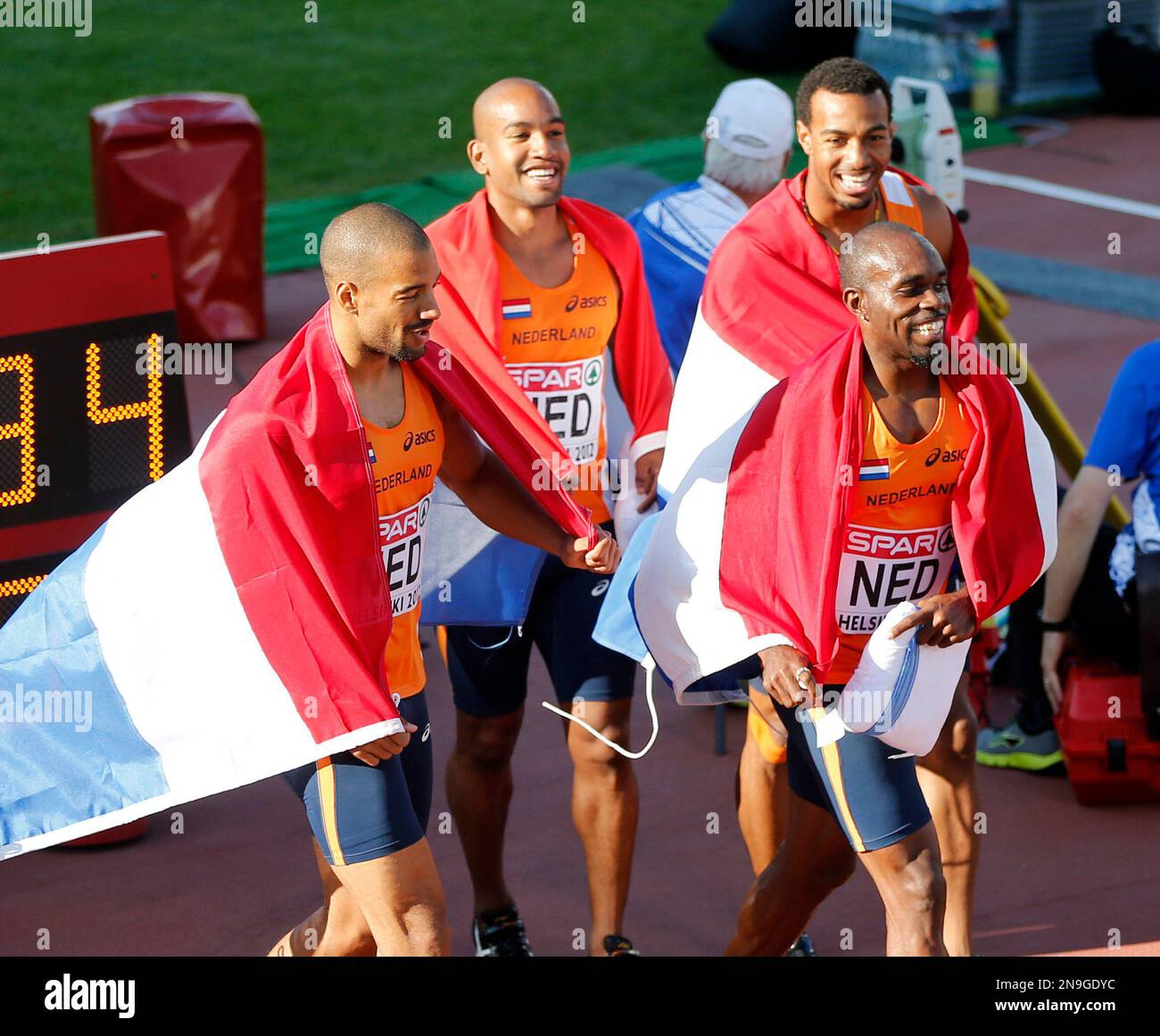 The Netherland's team poses with the flag after winning the Men's 4x100 ...