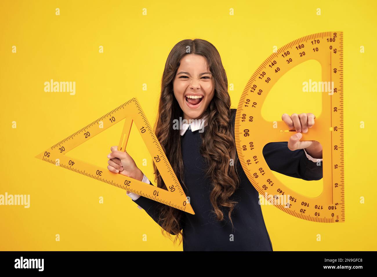 Excited face. Measuring school equipment. Schoolgirl holding measure ...