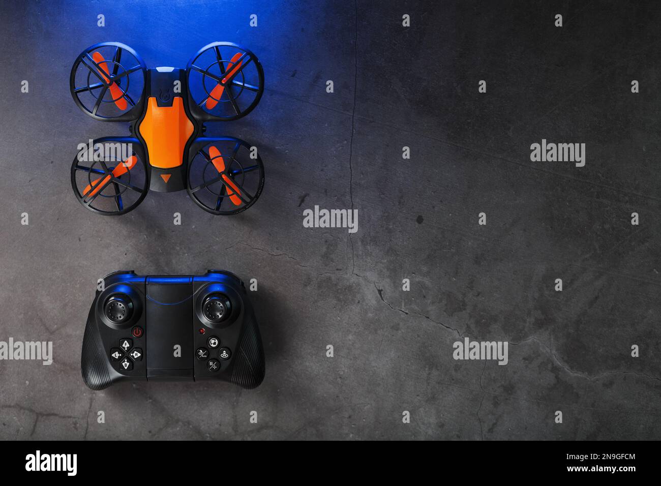 Quadcopter drone with joystick control and blue neon backlight, on a ...