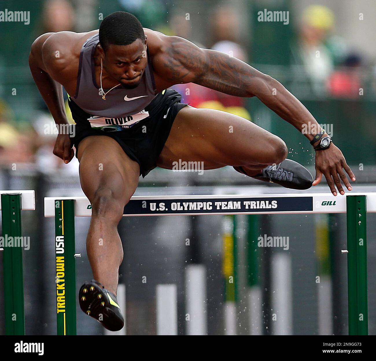 David Oliver competes in the semi-finals of the men's 110 meter hurdles ...